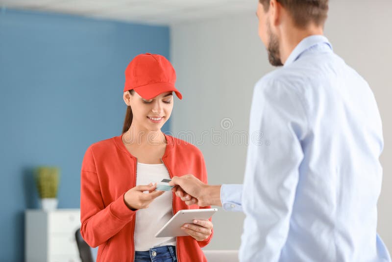 Man Paying for Delivery with Credit Card Indoors Stock Photo - Image of ...