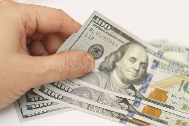 Man Paying by Stack of Paper Dollars Usa on the White Background Stock ...