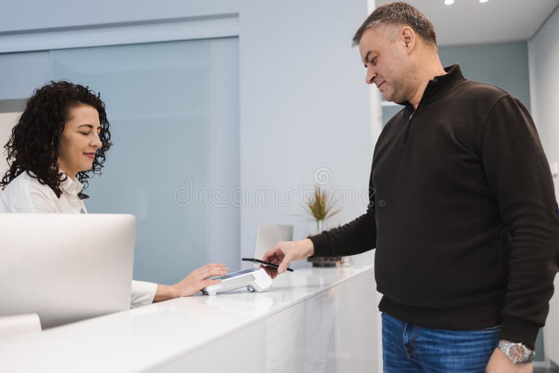 Man Pays for Services Using a Smartphone with Nfc in a Pos Terminal ...
