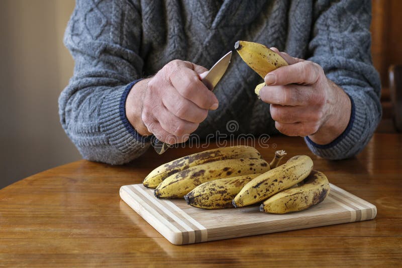 A man is peeling a banana stock image. Image of cuisine - 298559483