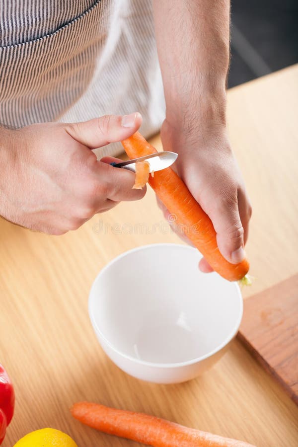 Man Peeling Carrot in Kitchen Stock Image - Image of cook, vegetarian ...