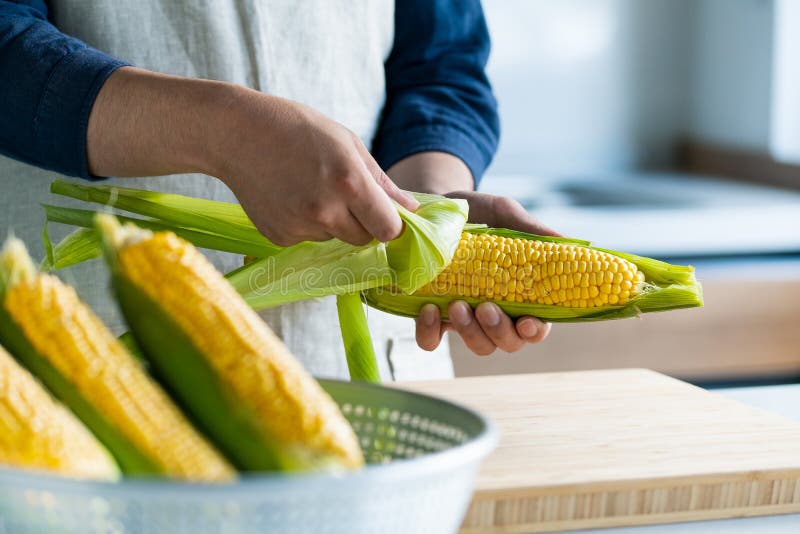 Man Peeling Corn Husk at Kitchen. Stock Image - Image of maize, grain ...