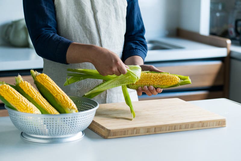 Man Peeling Corn Husk at Kitchen. Stock Photo - Image of farming, food ...