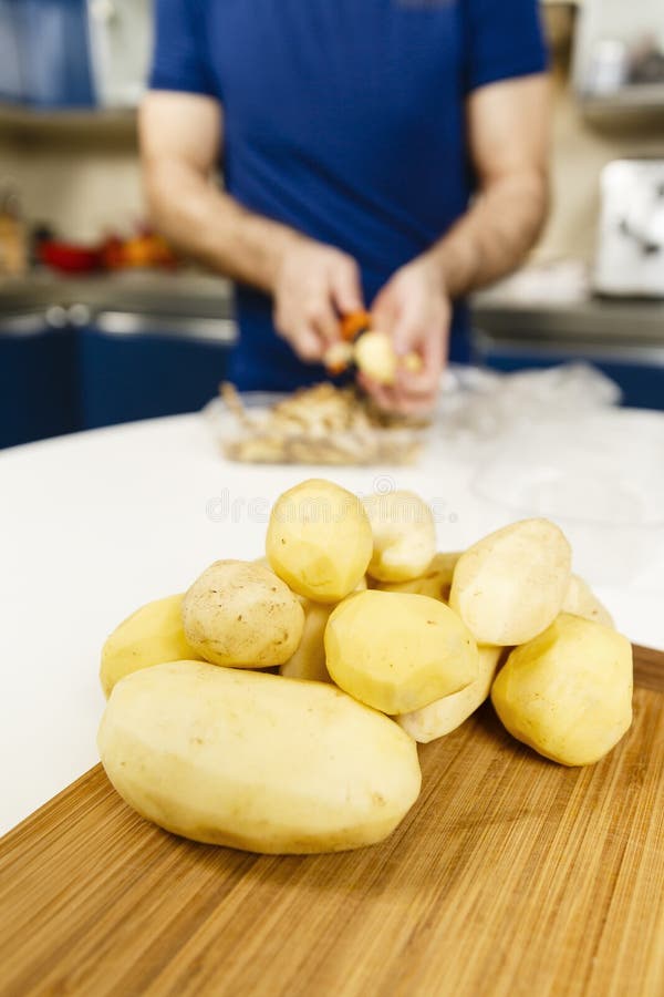 Man Peeling Potatoes on the Counter Stock Photo - Image of ingredient ...