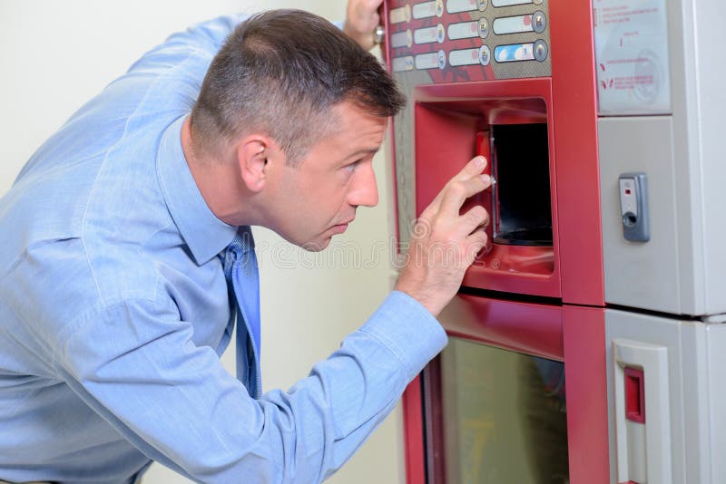 Man Peering Inside Drinks Machine Stock Image - Image of disappointment ...