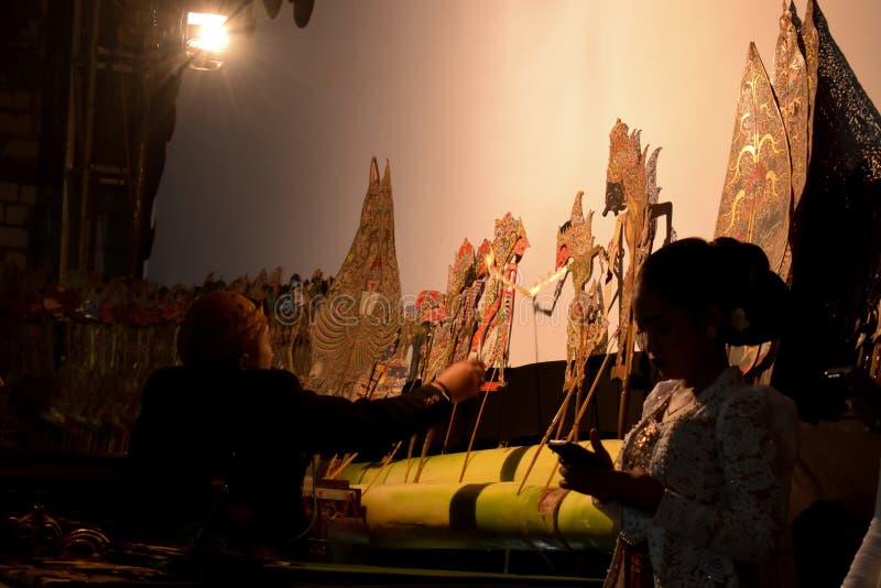 A Man Perform with Wayang or Traditional Javanese Puppet on Stage at ...