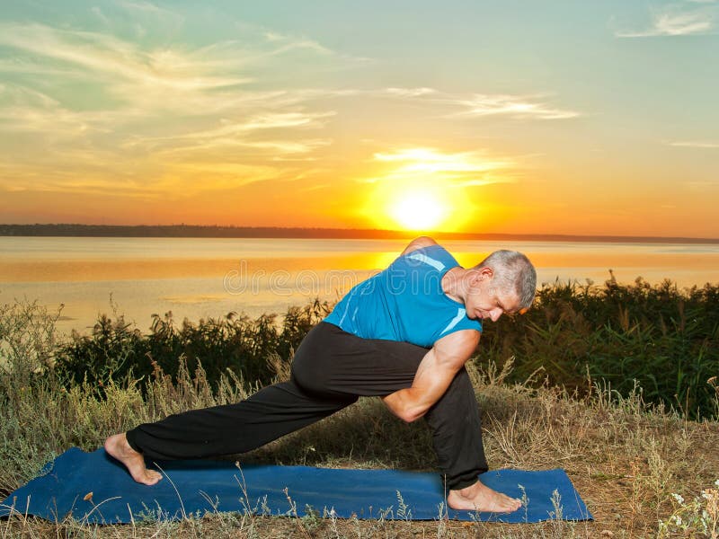 Man Performing Asana at Sunset Stock Image - Image of bound ...