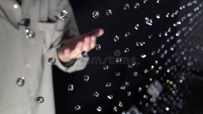 Man Performing Magic with Water Droplets Floating in Air Stock Video ...
