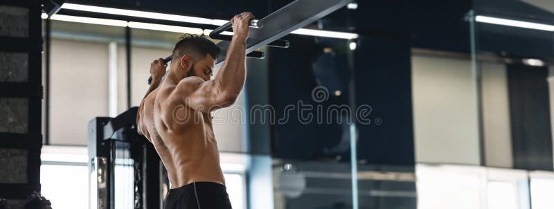 Man Performing Pull-ups in a Modern Gym during Workout Session Stock ...