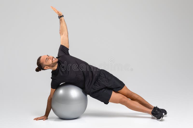 Man Exercising on Exercise Ball on Grey Background Stock Image - Image ...