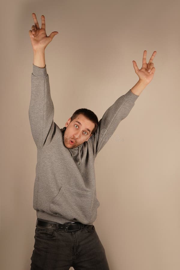 A Man Performs a Dance with Raised Arms, Highlighting Three Fingers on ...