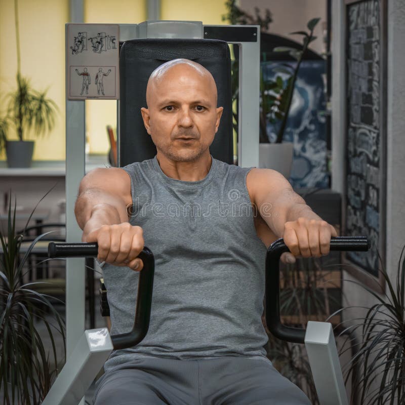 Man Performs an Exercise on a Simulator for Pumping Chest Muscles Stock ...