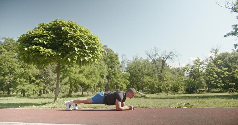 Man Doing Plank Exercise in Park Workout Routine, Focusing on Core ...