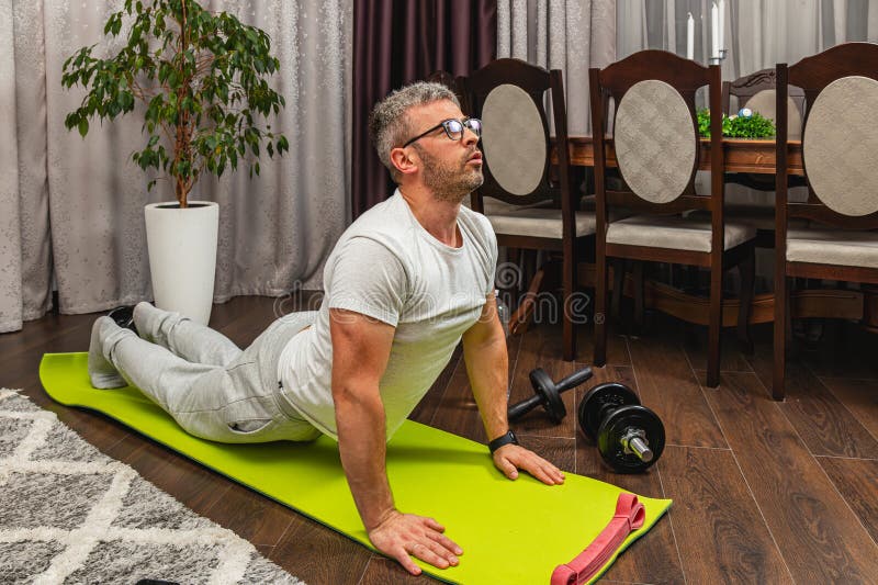 Man Practicing Yoga at Home on a Green Mat Stock Photo - Image of ...