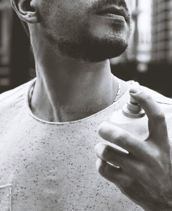 Guy Sprays Perfume on His Body Stock Photo - Image of handsome, care ...