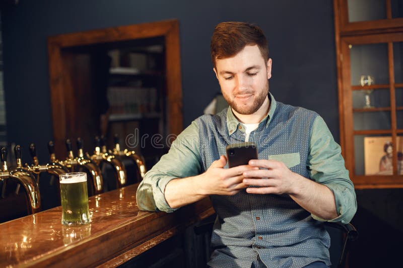 Man with a Phone at Bar with Beer Stock Photo - Image of leisure, phone ...