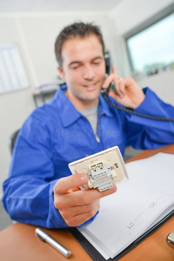 Man on Phone Holding Plug Socket Stock Photo - Image of reference, plug ...