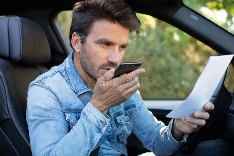 Man on Phone Looking at Documents in Car Stock Photo - Image of person ...