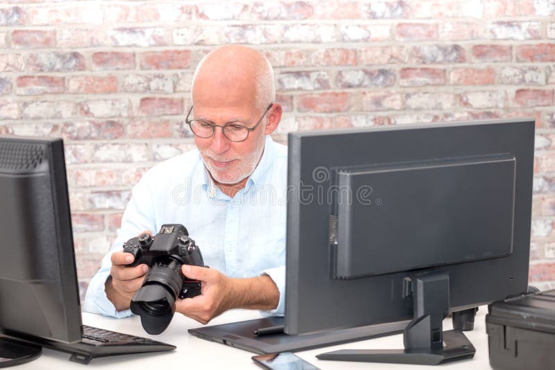 Photographer Watching a Camera at Office with Computer Stock Image ...