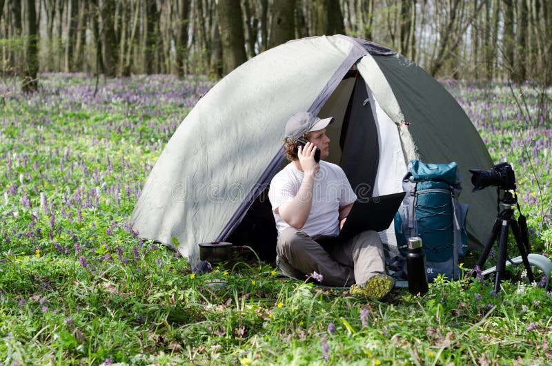 Man Photographer Working Outdoors in a Tent Camp. Stock Photo - Image ...