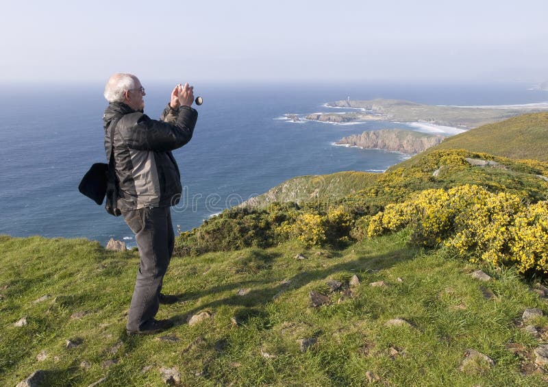 Man Photographing a Landscape Stock Photo - Image of skies, mature ...