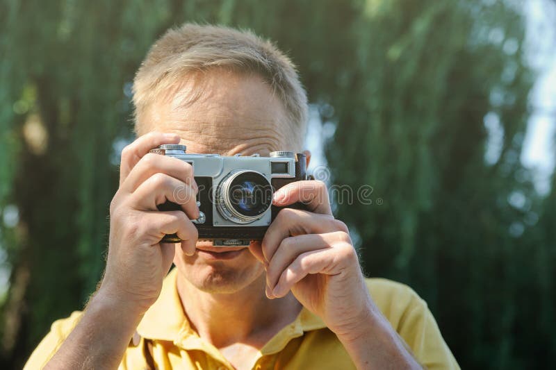 The Man is Photographing an Old Camera. Stock Photo - Image of ...