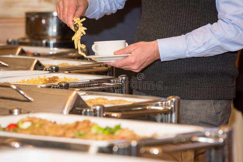 Man Picking Food from Chafing Dish Heaters Stock Image - Image of beef ...