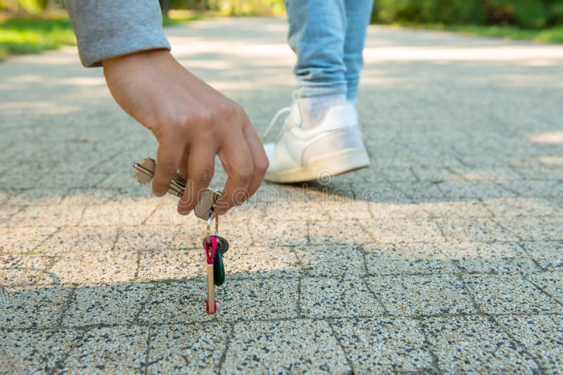 Man Picking Lost Keys from Ground, Closeup. Space for Text Stock Photo ...