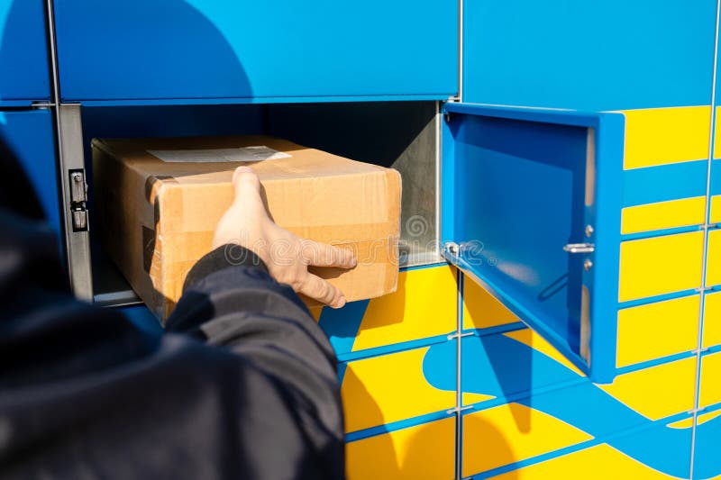 Man Picking Up or Dropping Off a Parcel at a Self-Service Locker Stock ...