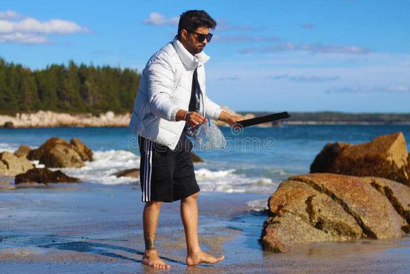 Man Picking Up Litter on Beach. Stock Image - Image of winter, sign ...