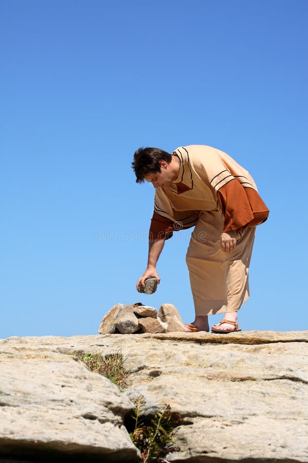 Man picking up rock - sin stock image. Image of human - 4033265