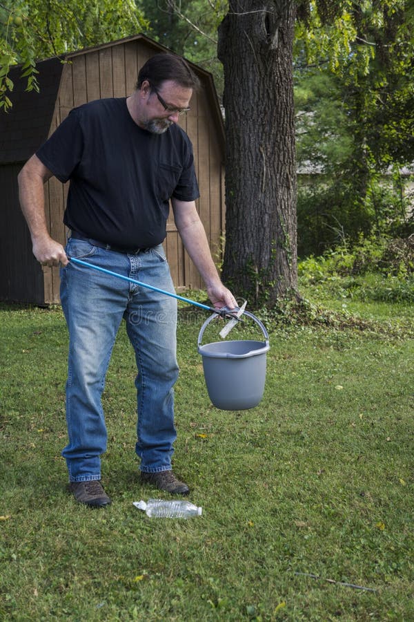 Man Picking Up Trash with Pick Up Tool Stock Image - Image of bucket ...