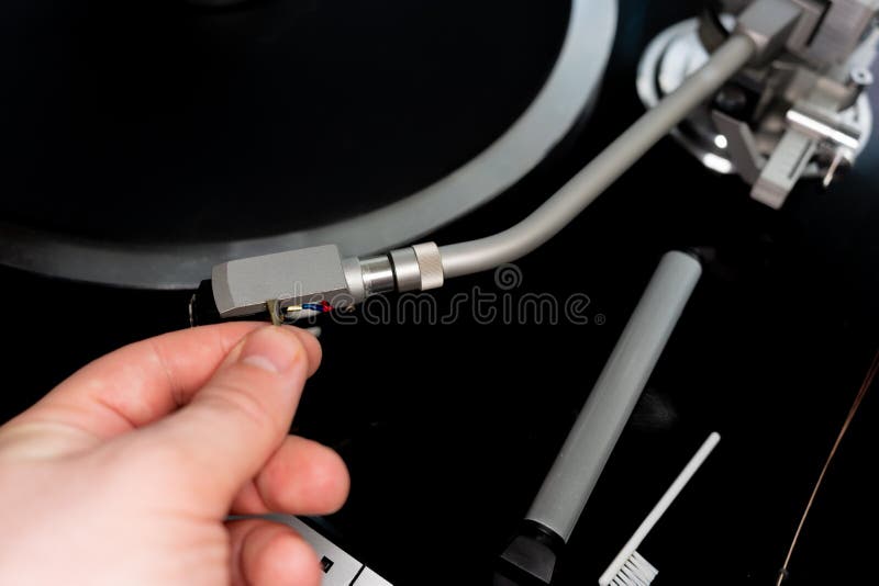 Man Picks Up a Shell with a Turntable Head Stock Photo - Image of ...