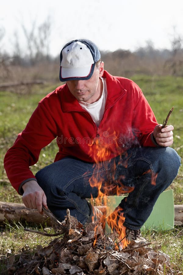 Man Making Fire In Countryside Stock Photo - Image of adult, scenery ...