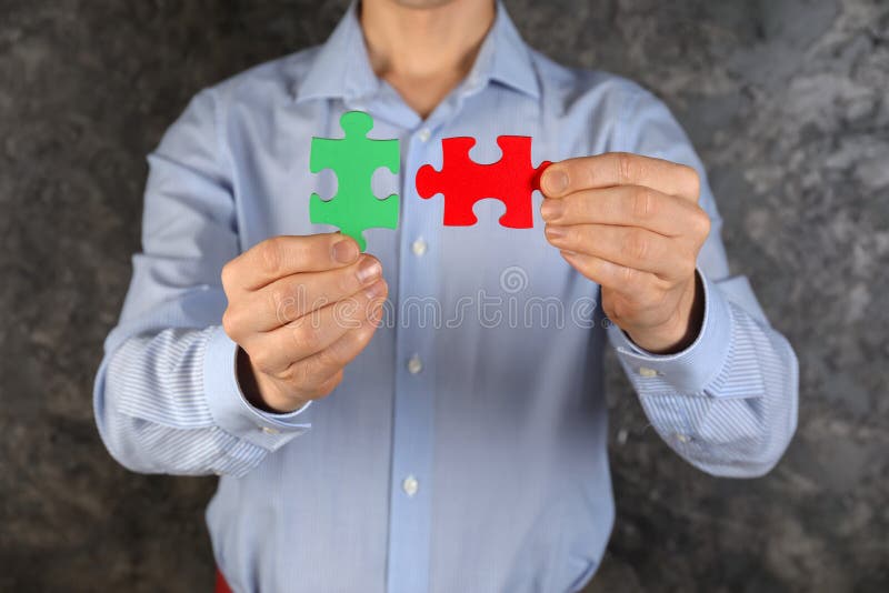 Man with Pieces of Color Puzzle on Grey Background Stock Photo - Image ...