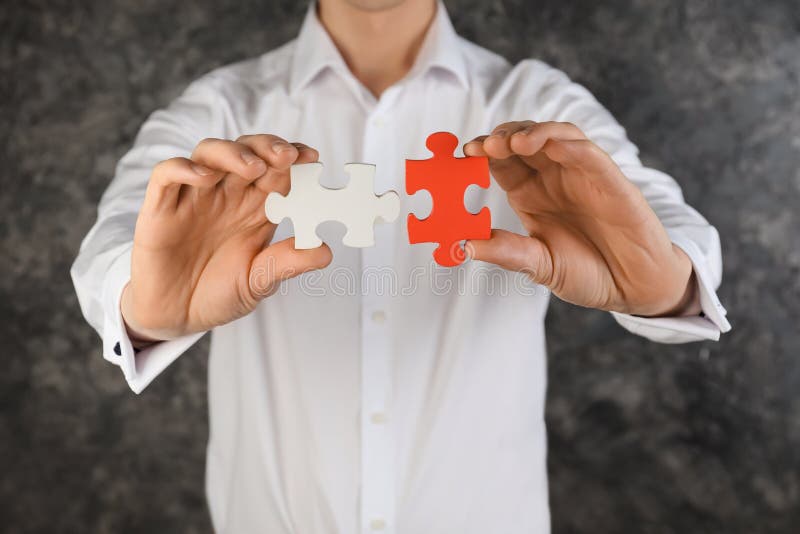 Man with Pieces of Color Puzzle on Grey Background Stock Image - Image ...