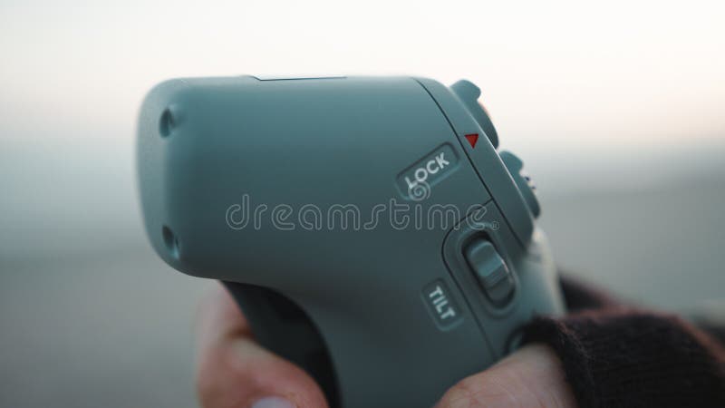 Man Pilot a Drone with Remote Single Hand Controller on the Beach Near ...