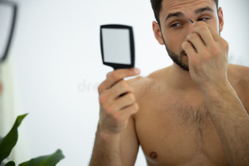Man Pinching Eyebrows in Mirror Reflection Stock Photo - Image of ...