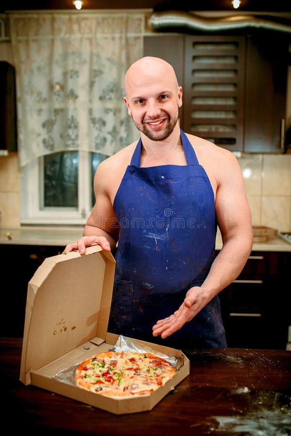 Man with pizza stock image. Image of kitchen, interior - 112128037