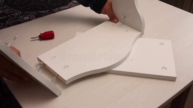 A Man Places the Elements of a Table Shelf on Furniture Ties. Self ...