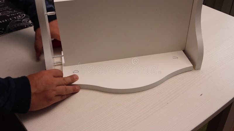A Man Places the Elements of a Table Shelf on Furniture Ties. Self ...