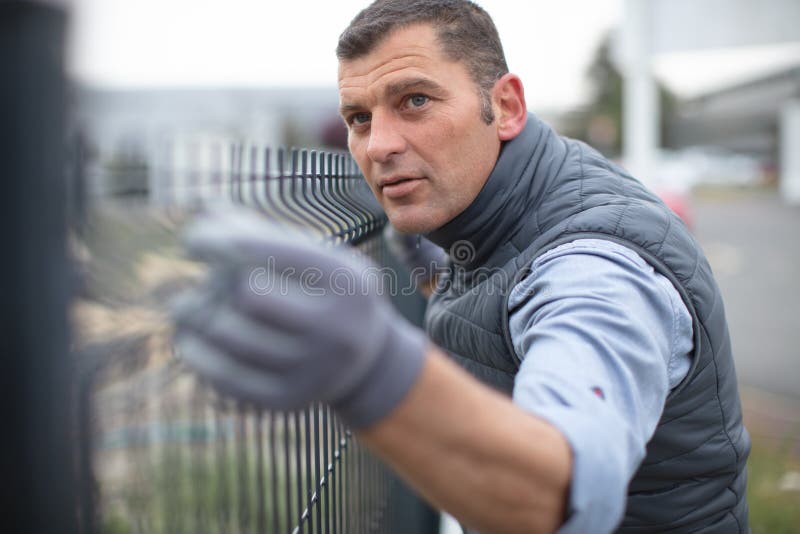 Man Places Metal Fence Panel Stock Image - Image of fencing, industry ...