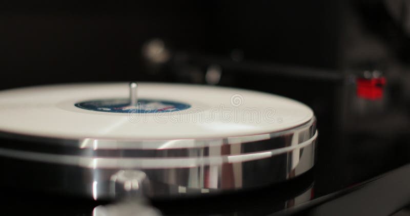 Man Places a White Disk on a Vinyl Player. Vinyl Record Gets Placed on ...
