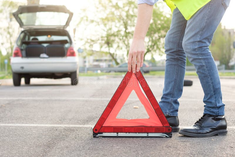 Man Placing a Reflective Red Triangle Stock Photo - Image of stressed ...