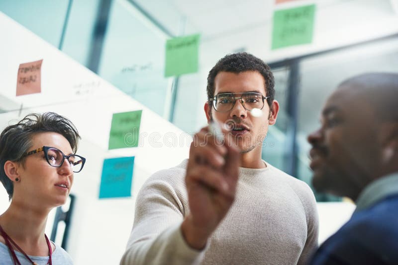 The Man with the Plan. a Group of Designers Brainstorming with Notes on ...