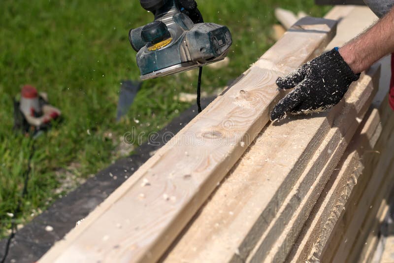 Man Planing Boards with Electric Tools, Chips Flying in All Directions ...