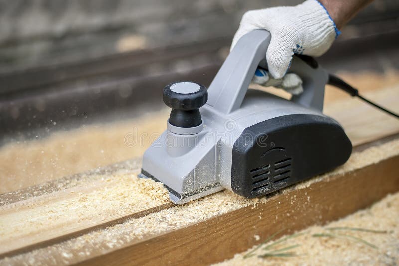 Man Planing Boards with Electric Tools, Chips Flying in All Directions ...