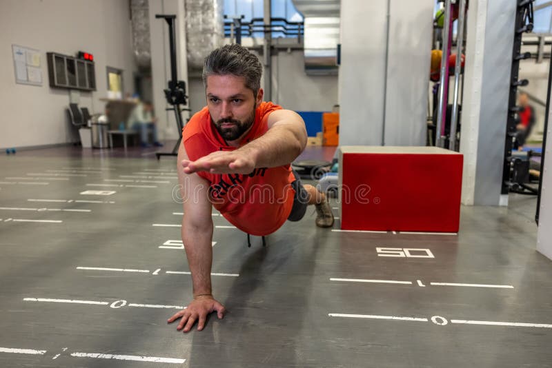 Confident Muscular Young Man Wearing Sport Wear and Doing Plank ...