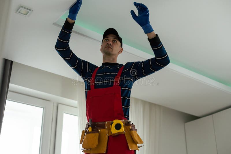 Man Plasterer Construction Worker at Work, Takes Plaster from Bucket ...
