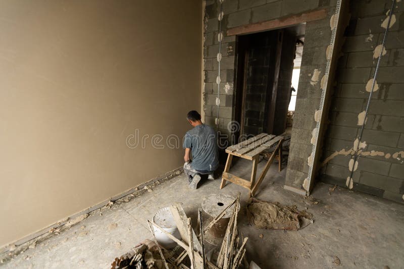 Man Plasterer Construction Worker at Work with Trowel, Plastering a ...
